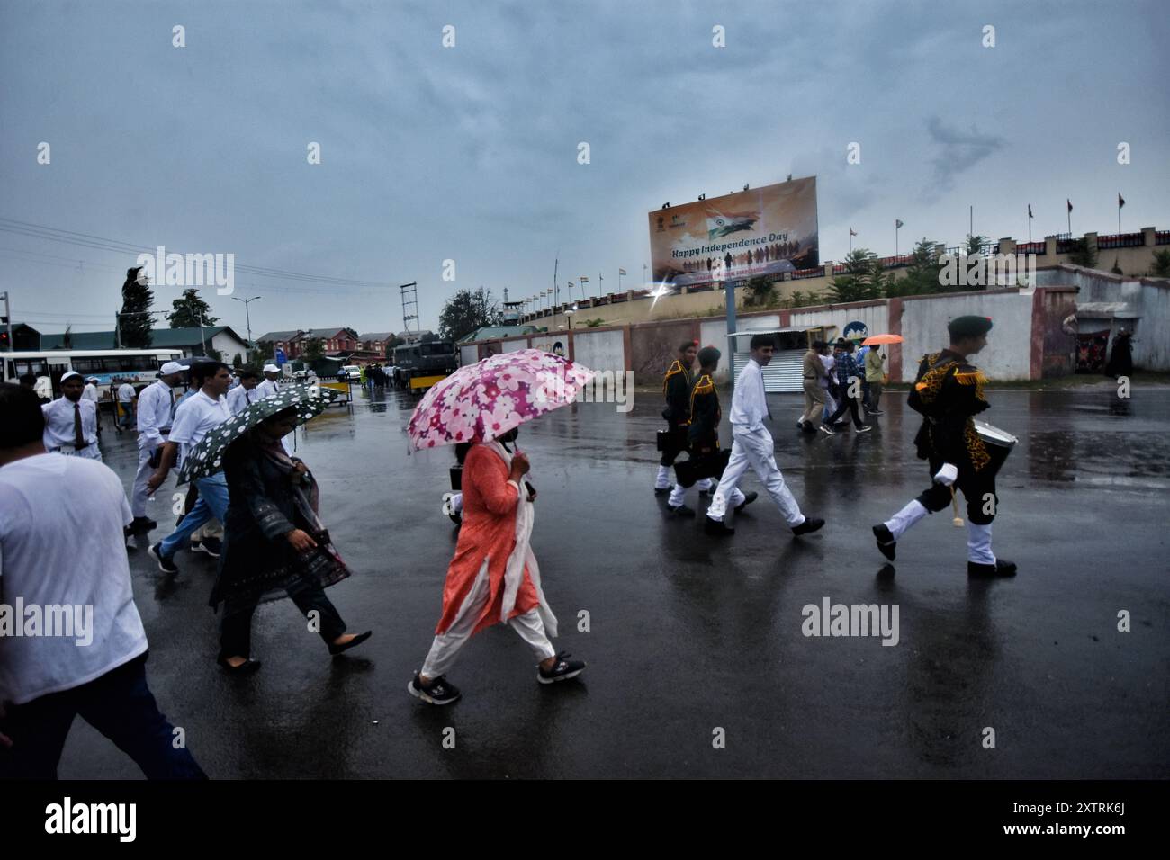 Government employees walk in rain towards the venue of India's 78th ...