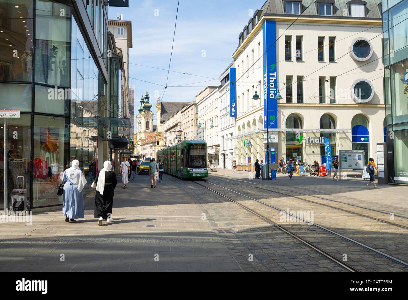 Linz, Austria. August 12, 2024. a tram passing through a street in the ...
