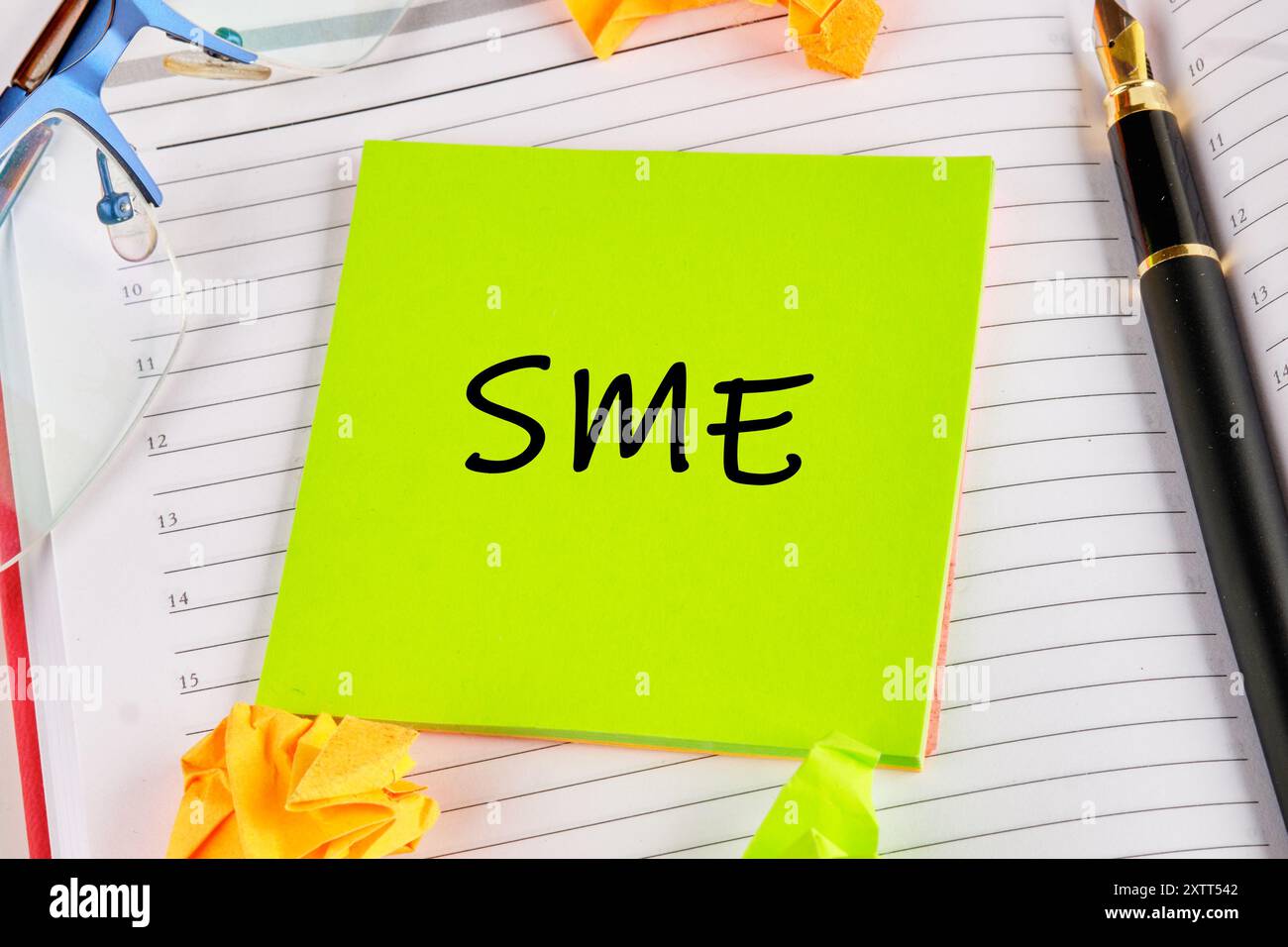 SME, small and medium enterprise. on a light green sticker lying on the ...