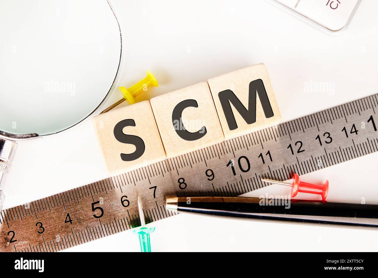 SCM short for Supply Chain Management. SCM on wooden cubes next to the ...