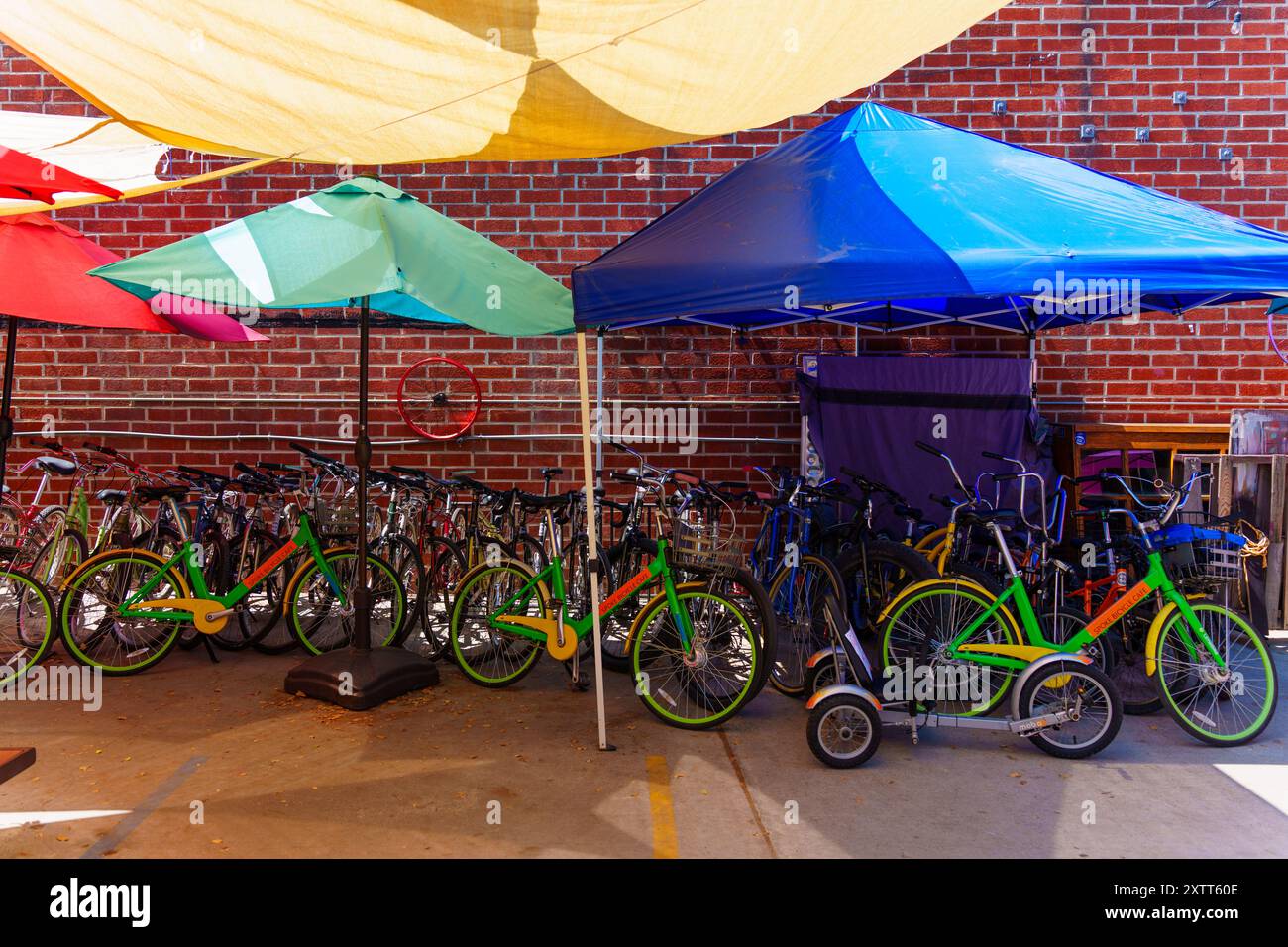 Los Angeles, California - April 21, 2024: Bicycles lined up under colorful canopies at Spoke ...