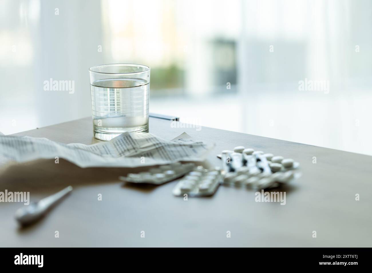 pills, medical prescription and medical thermometer on the table ...