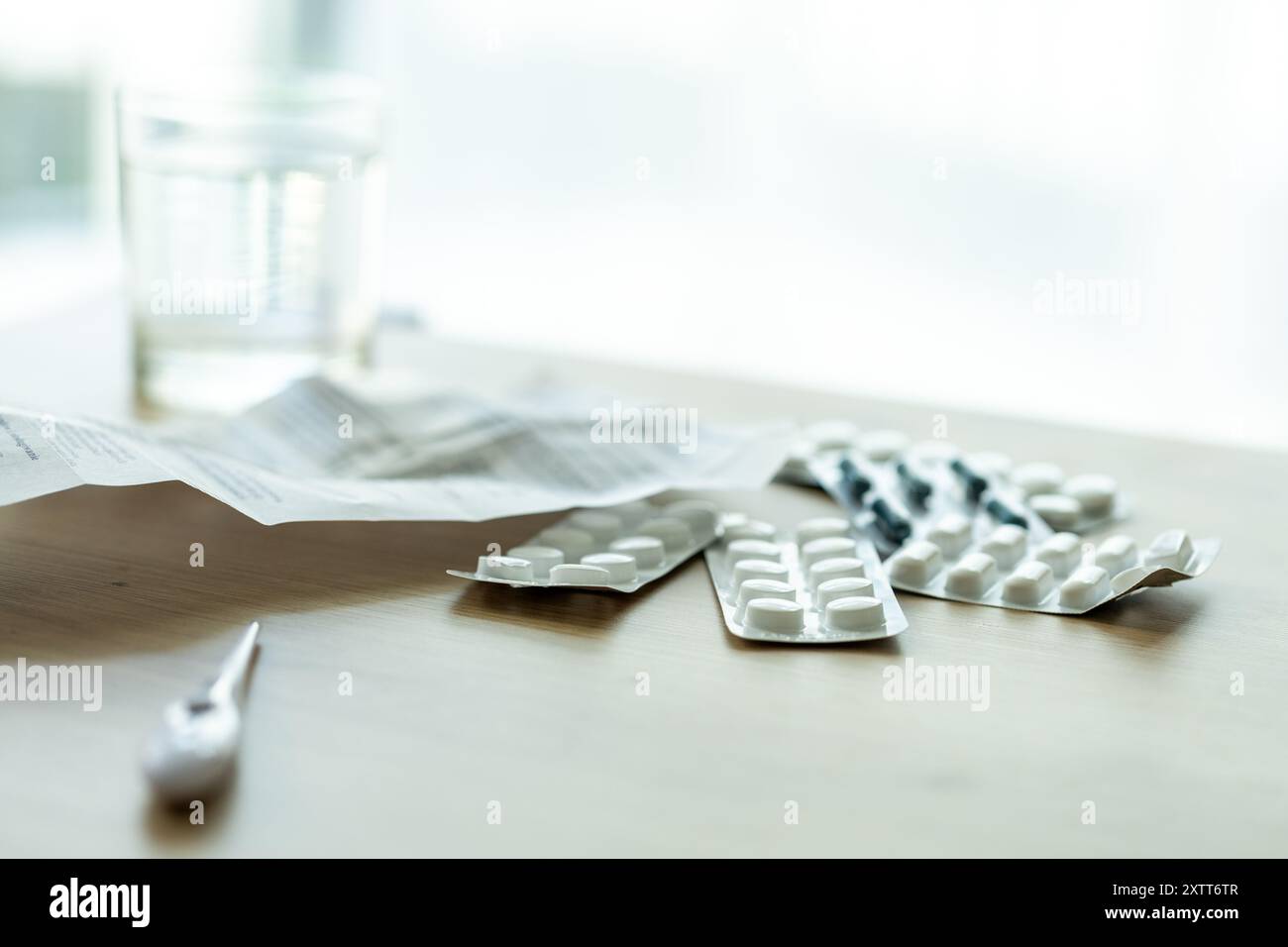 pills, medical prescription and medical thermometer on the table ...