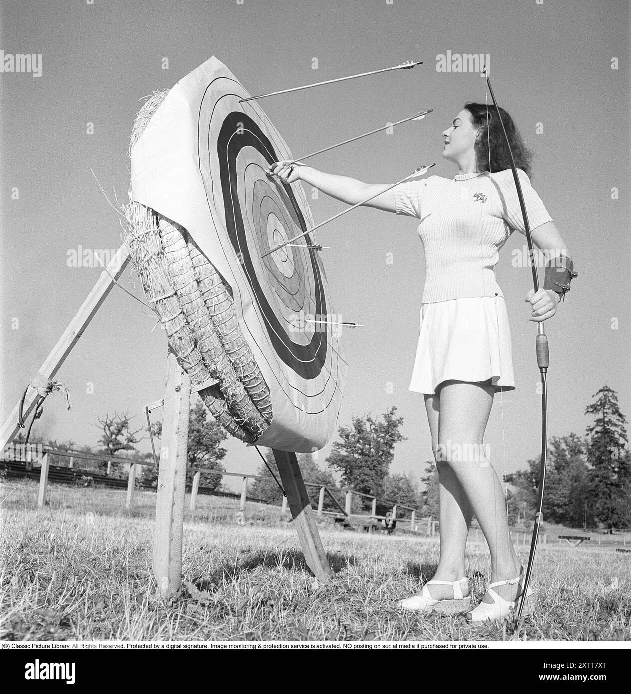Archery in the 1940s. The young swedish actress Mimi Nelson in front of ...