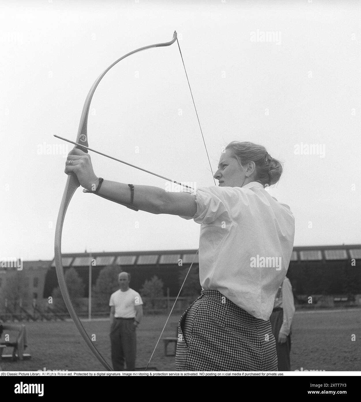 Archery 1957. A woman from the Stockholm archery club with her bow and ...