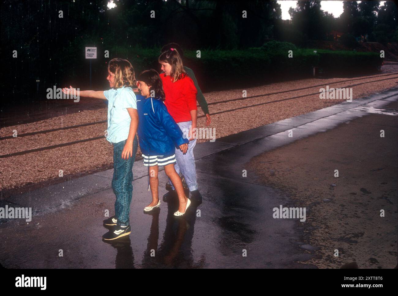 Children excited by rain after a long dry spell in Port Augusta, South ...
