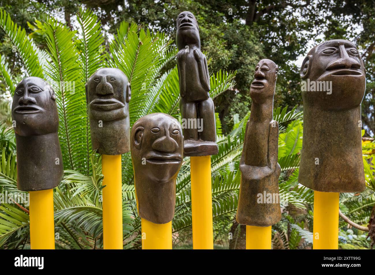 Close up of sculptures on yellow poles seen in Monte Palace Gardens ...