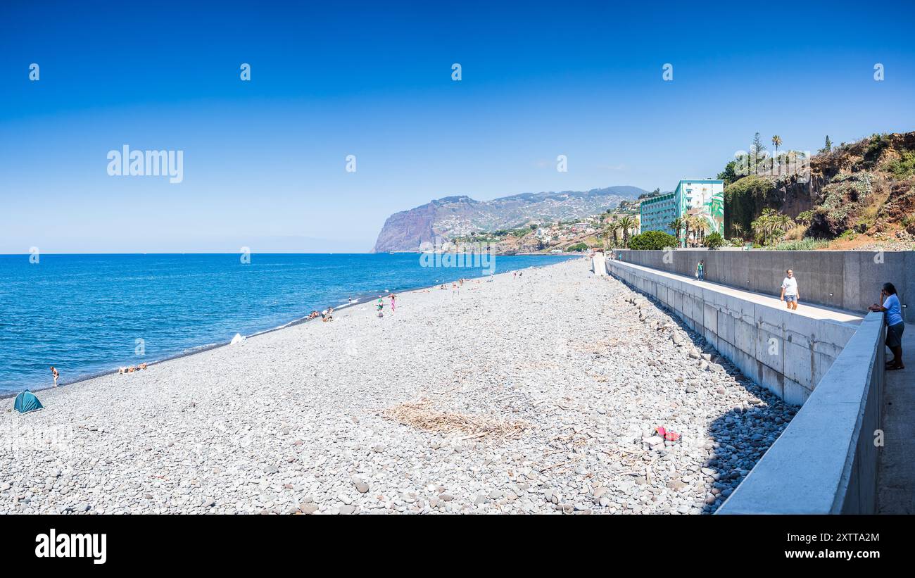A multi image panorama of Praia Formosa with sunbathers dotted on the ...