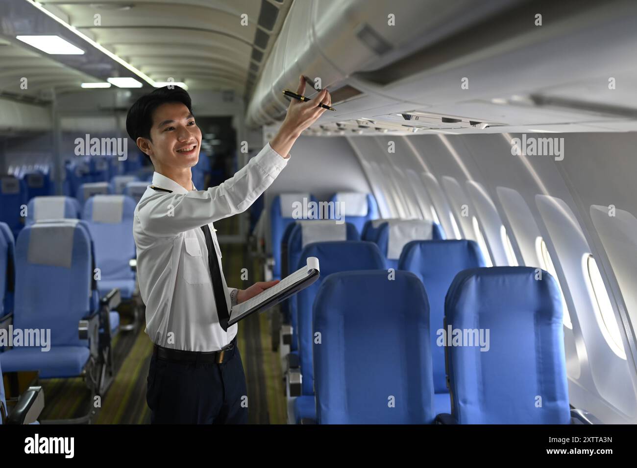 Smiling flight attendant or airline crew member preparing flight and ...
