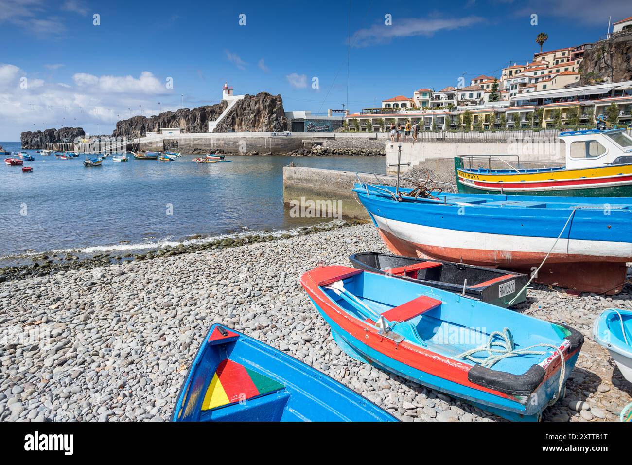 Colourful fishing boats on the pebble beach of Camara de Lobos, a ...