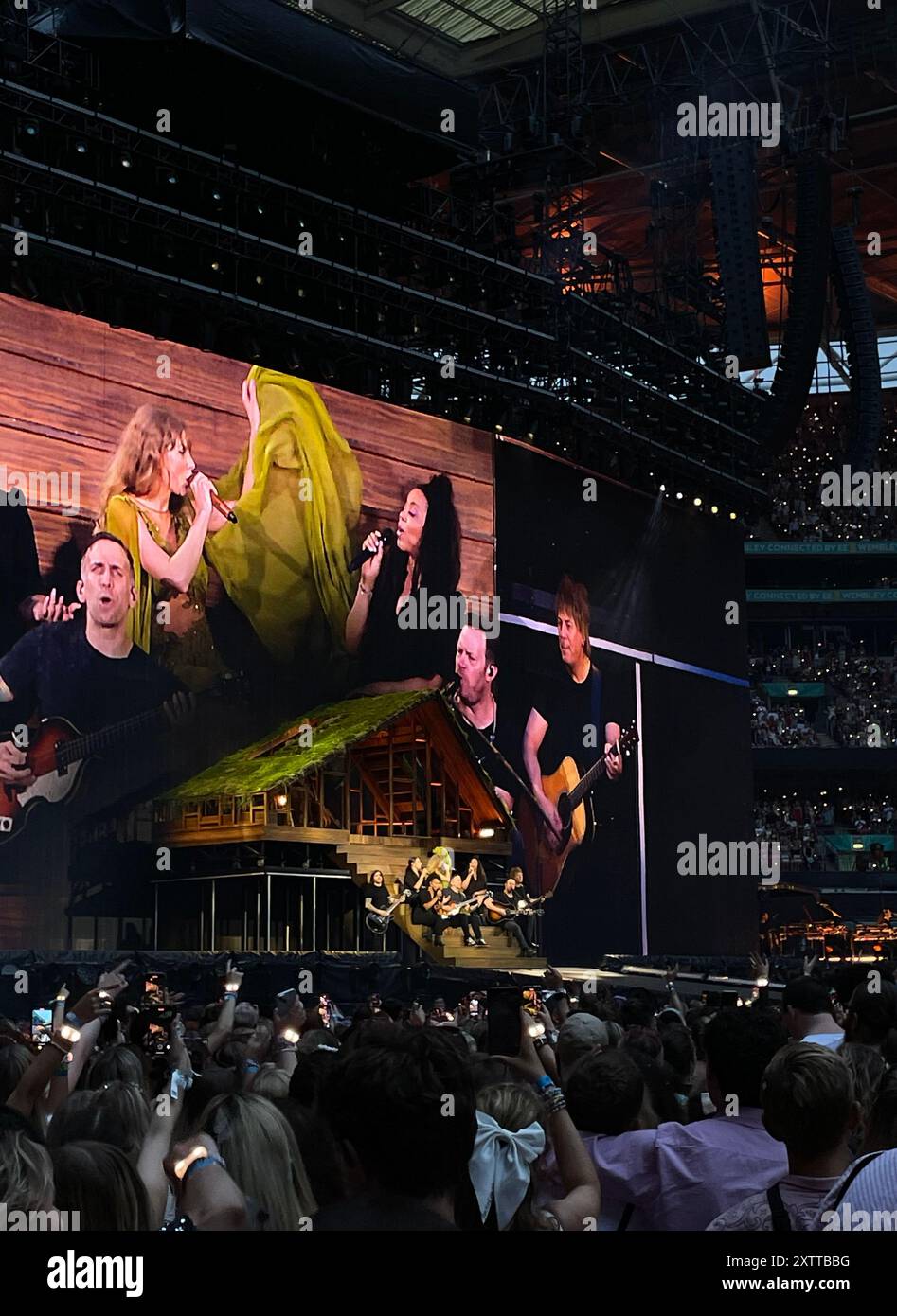 Taylor Swift performs on stage, as seen on a big screen, during her ...
