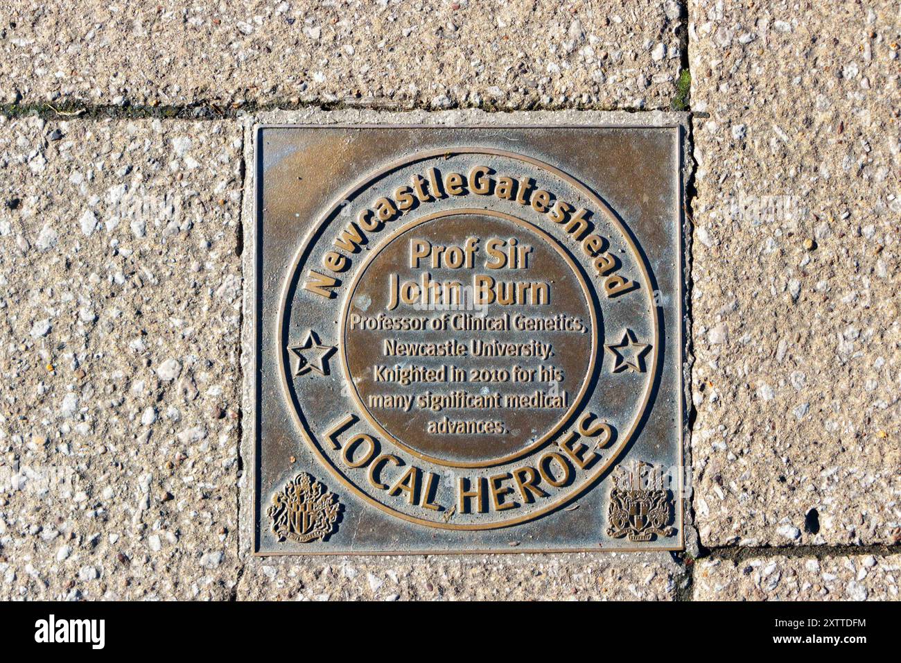 brass plaques to famous local heroes set in the quayside pavement in ...