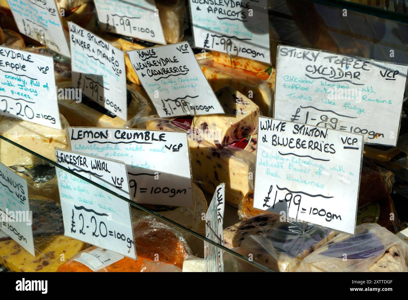 handwritten labels on artisanal cheese varieties on stall display in ...