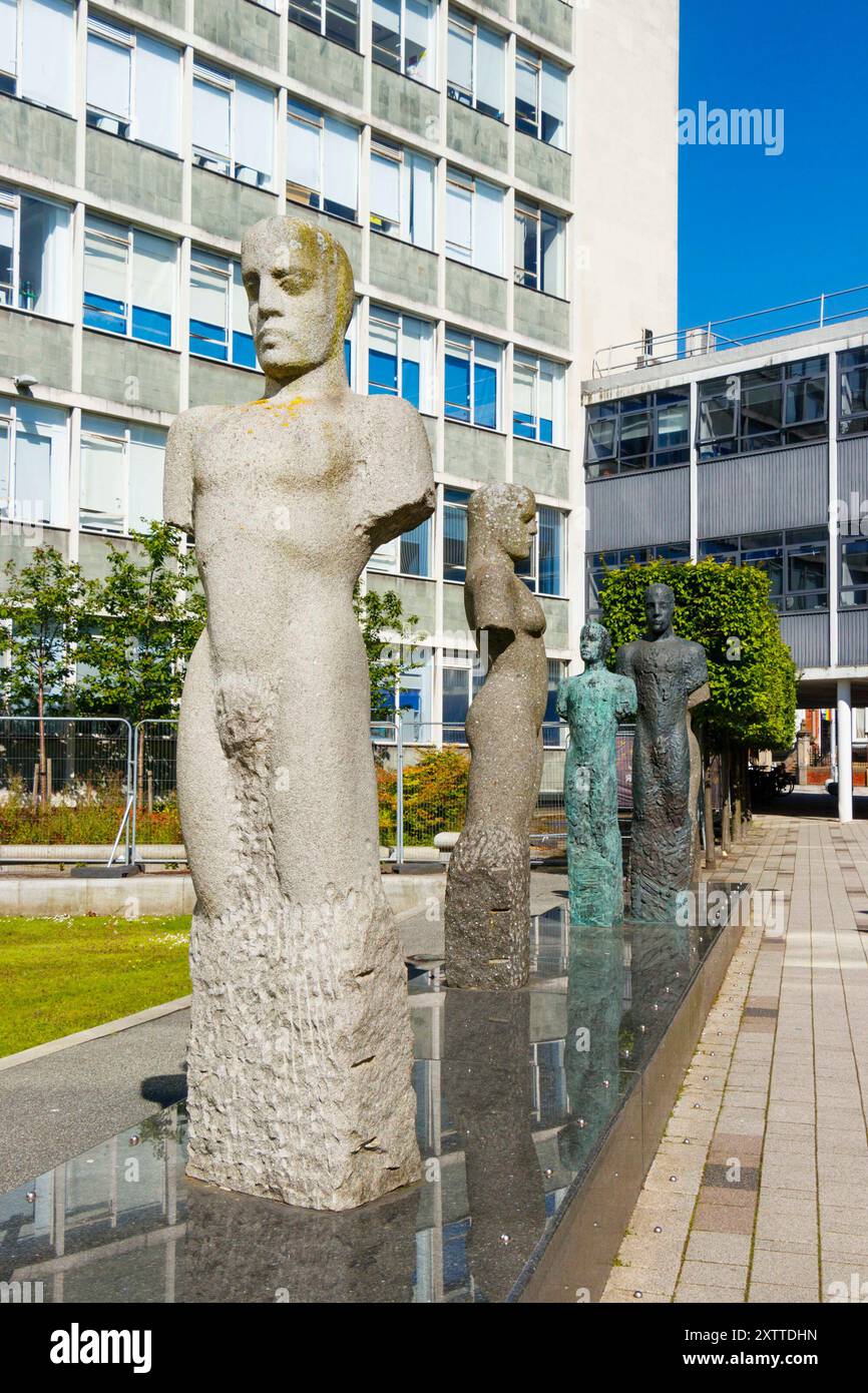 Outdoor view of multiple bronze sculptures of human forms Five Figures ...