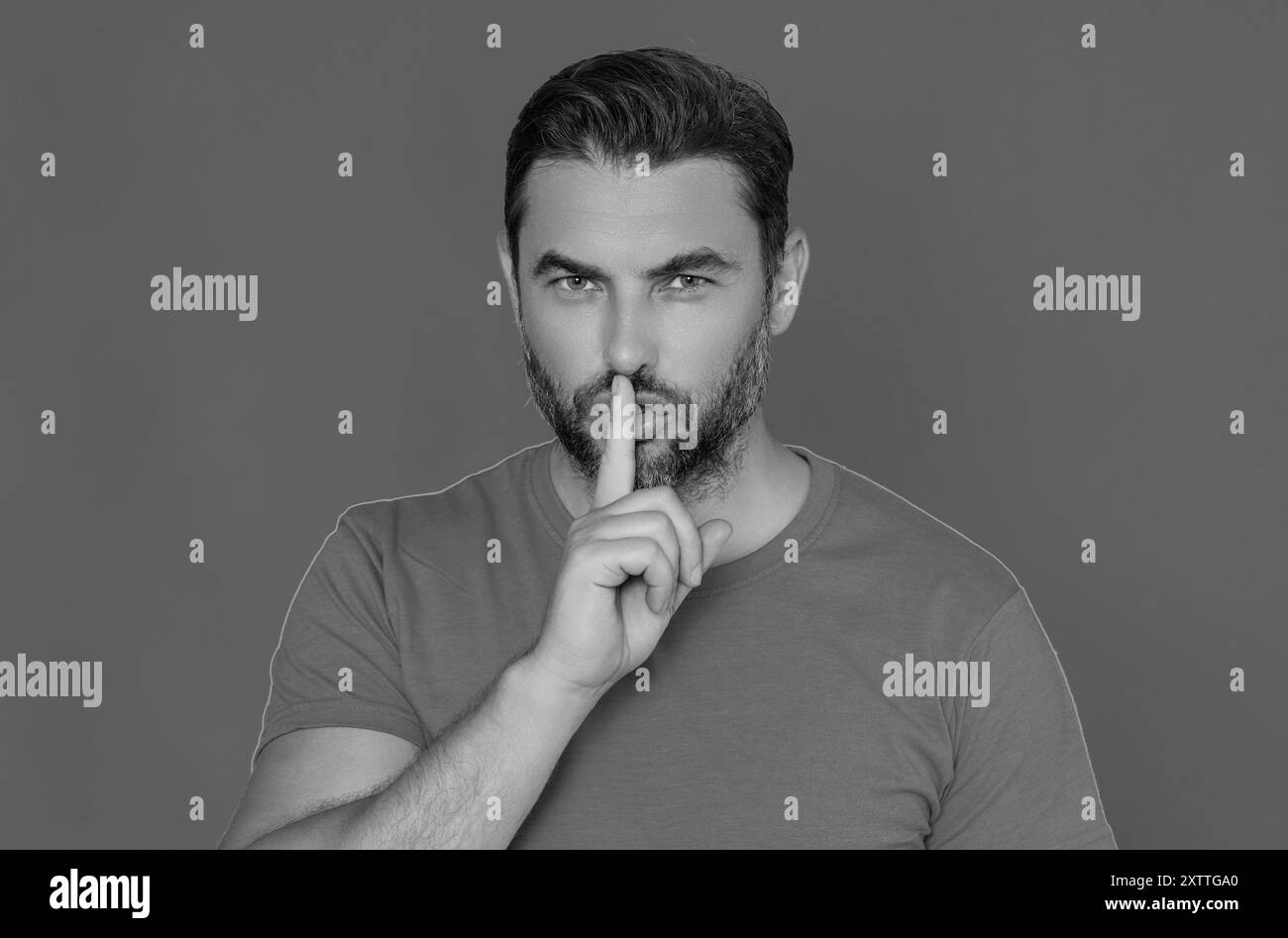 Shh man. Portrait of man showing shh taboo sign with finger to lips ...