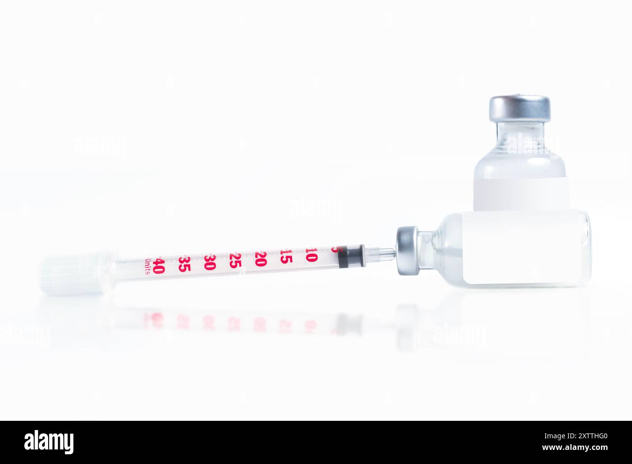 Medical syringe and vaccine vial isolated on a white background with ...