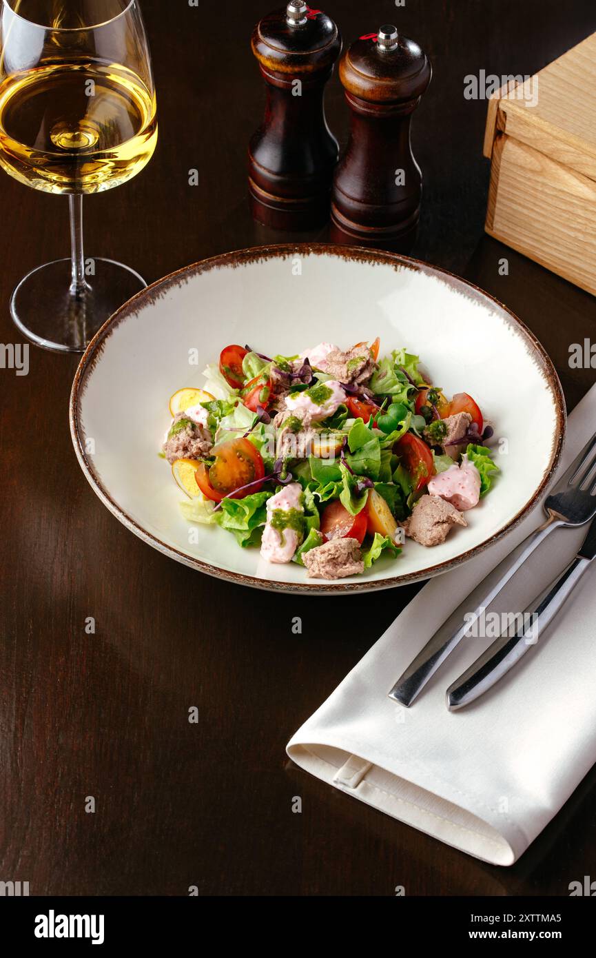 salad with vegetables and cod liver. restaurant menu Stock Photo - Alamy