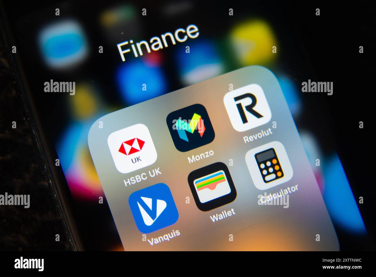 Close-up of a smartphone screen showing popular finance and banking apps including Revolut ...