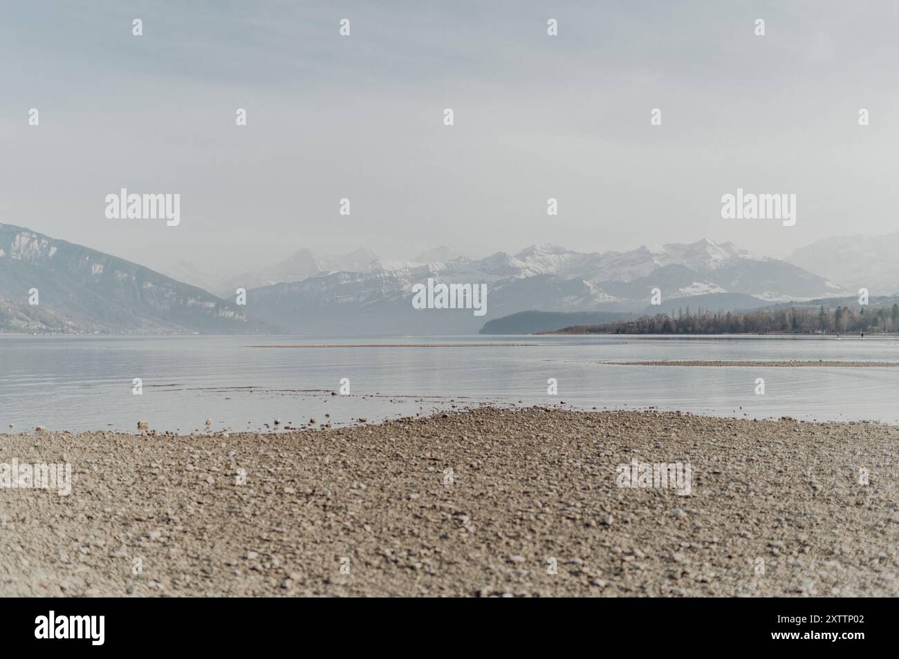 Snowy mountains and tranquil winter scene at Lake Thun, Switzerland ...