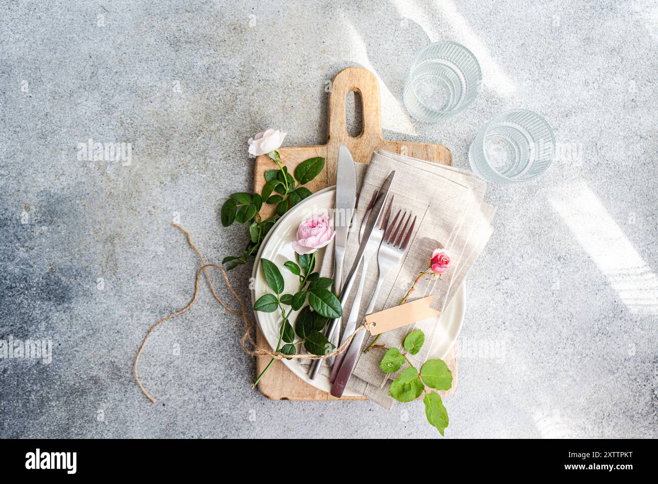 Table setting with pink rose flowers Stock Photo - Alamy