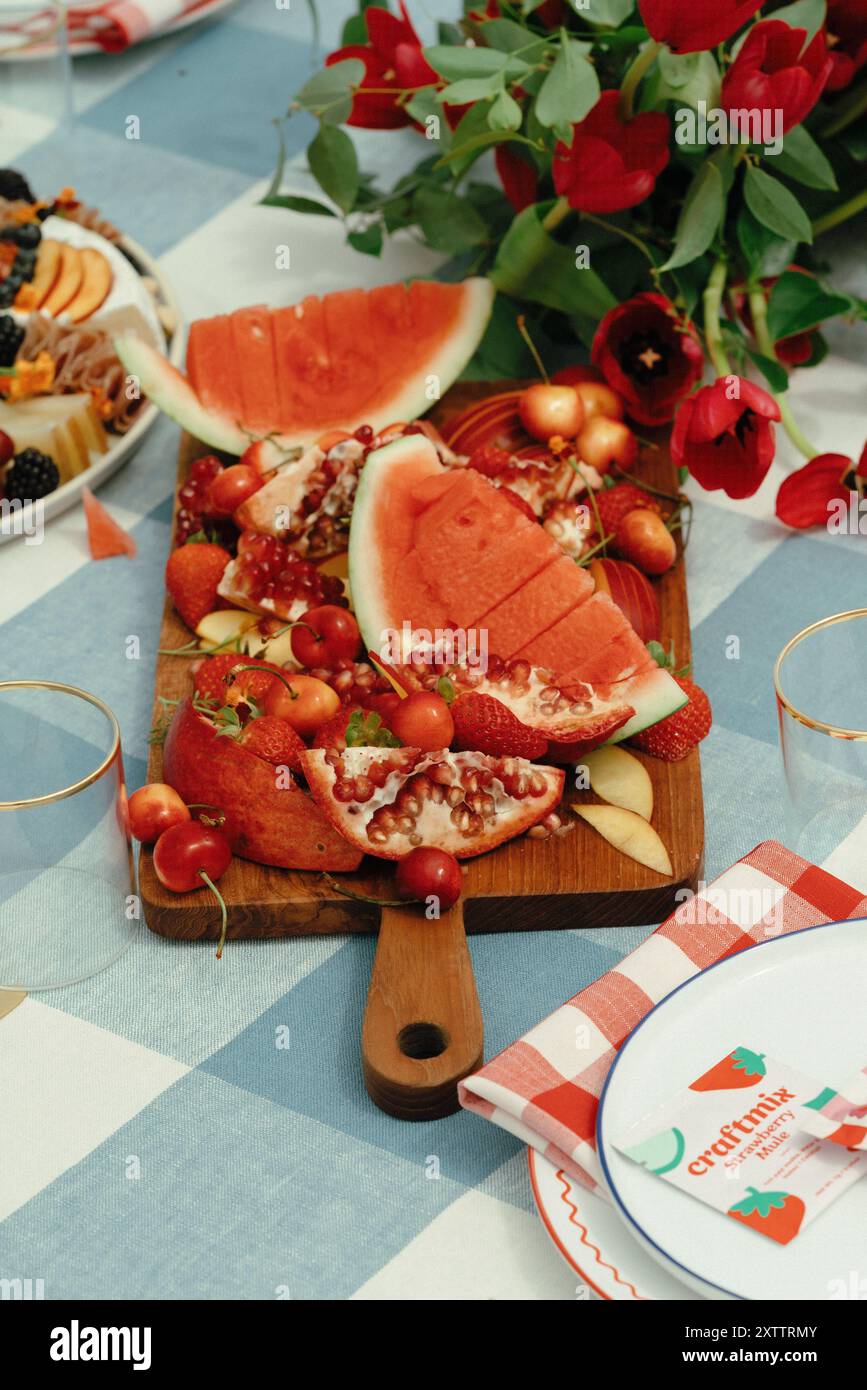 fruit platter with watermelon, cherries, and pomegranates on a picnic ...
