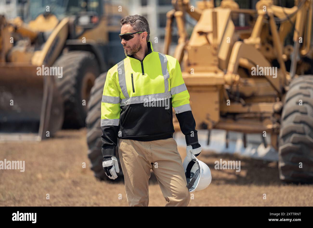 Machinery builder at buildings background. Excavator loader tractor and ...