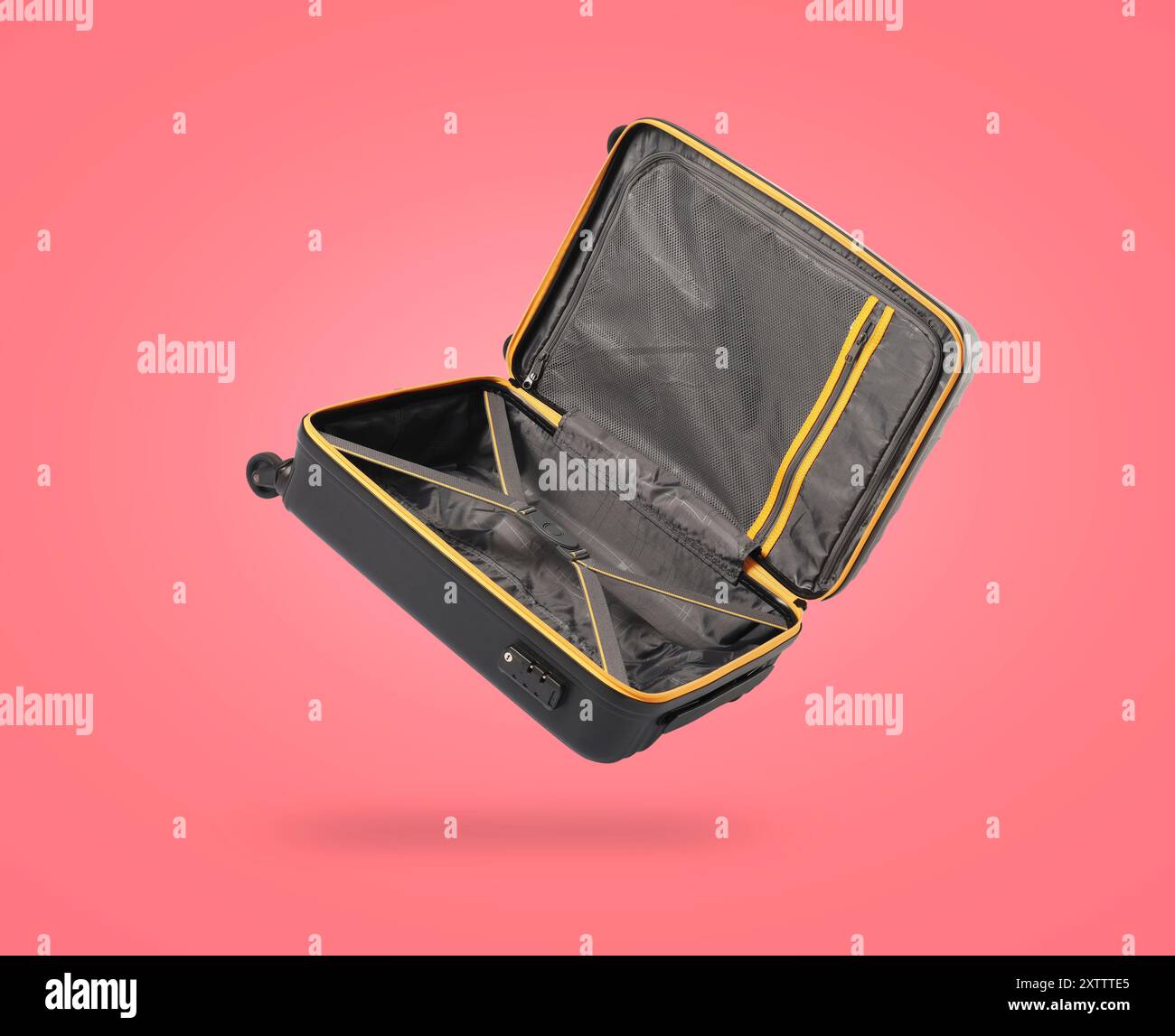 Open empty suitcase in air on coral background Stock Photo - Alamy