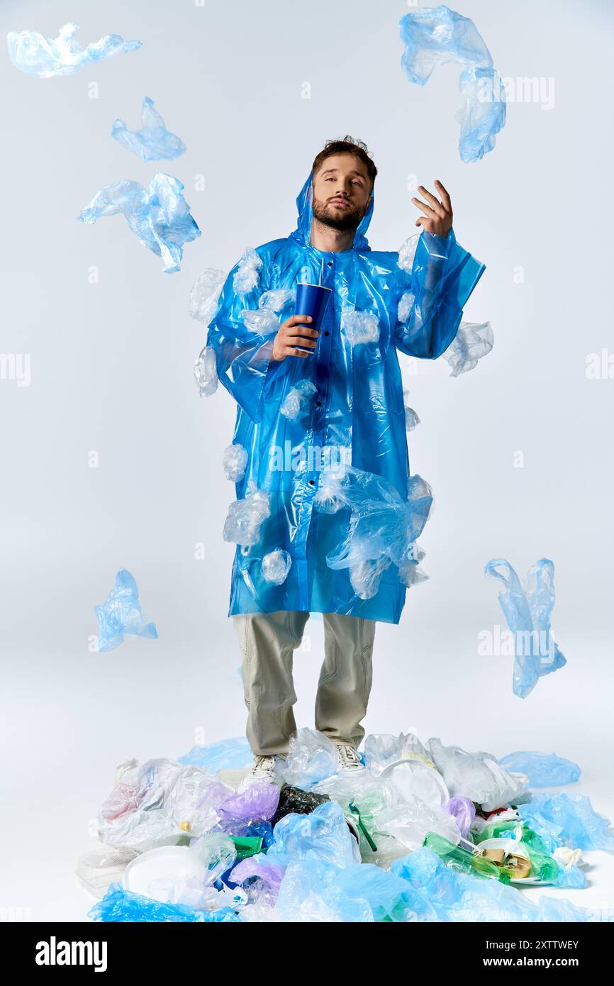 Man in raincoat stands in plastic waste surrounded by bags Stock Photo ...