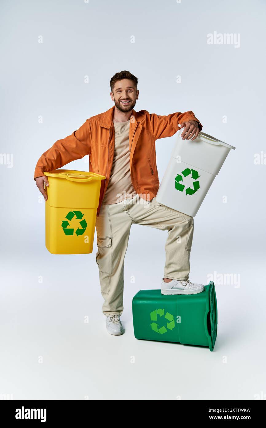 A man stands proudly with recycling bins, demonstrating his commitment ...