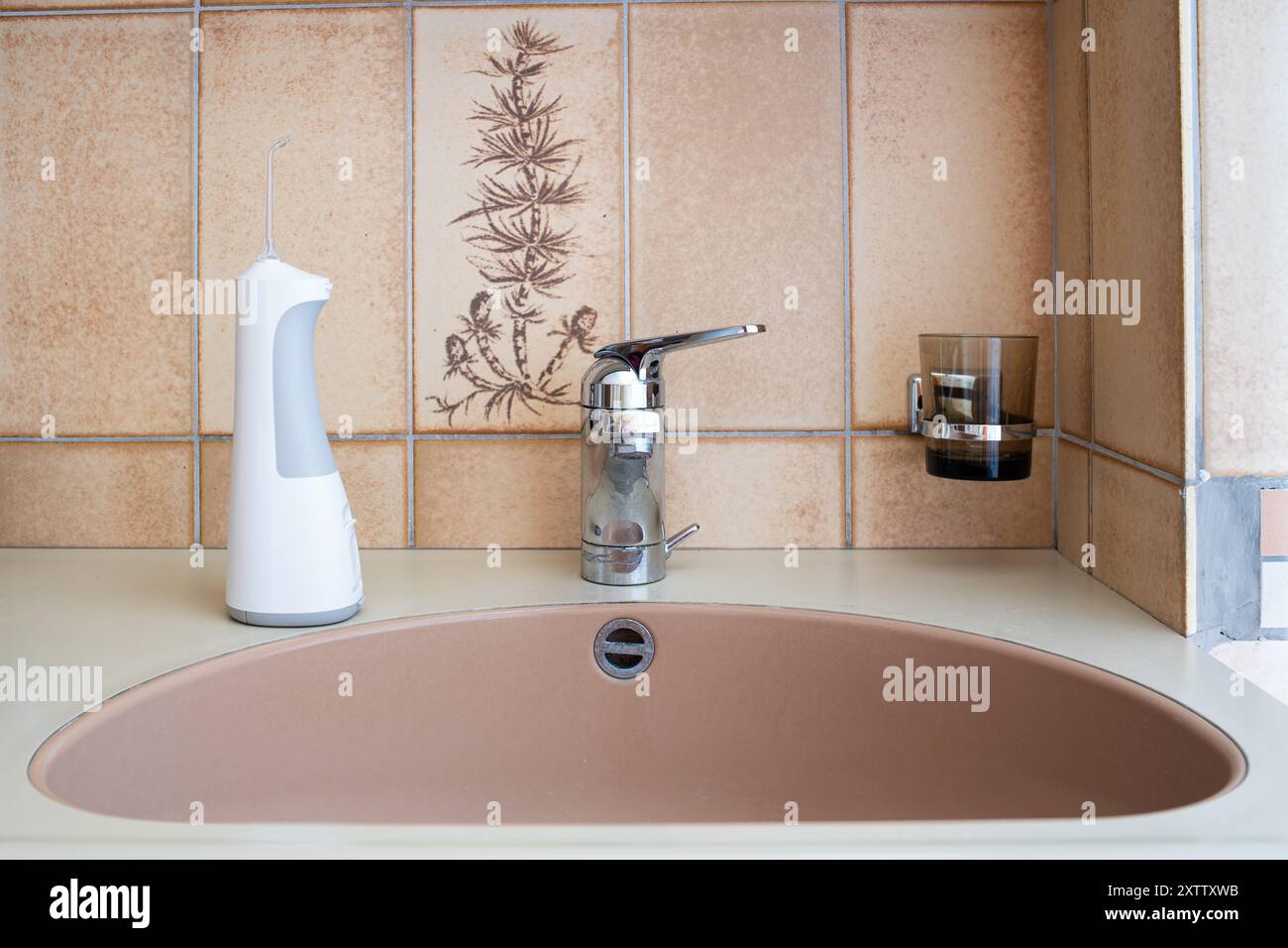 Home bathroom sink and dental water flosser. Close up shot, no people ...