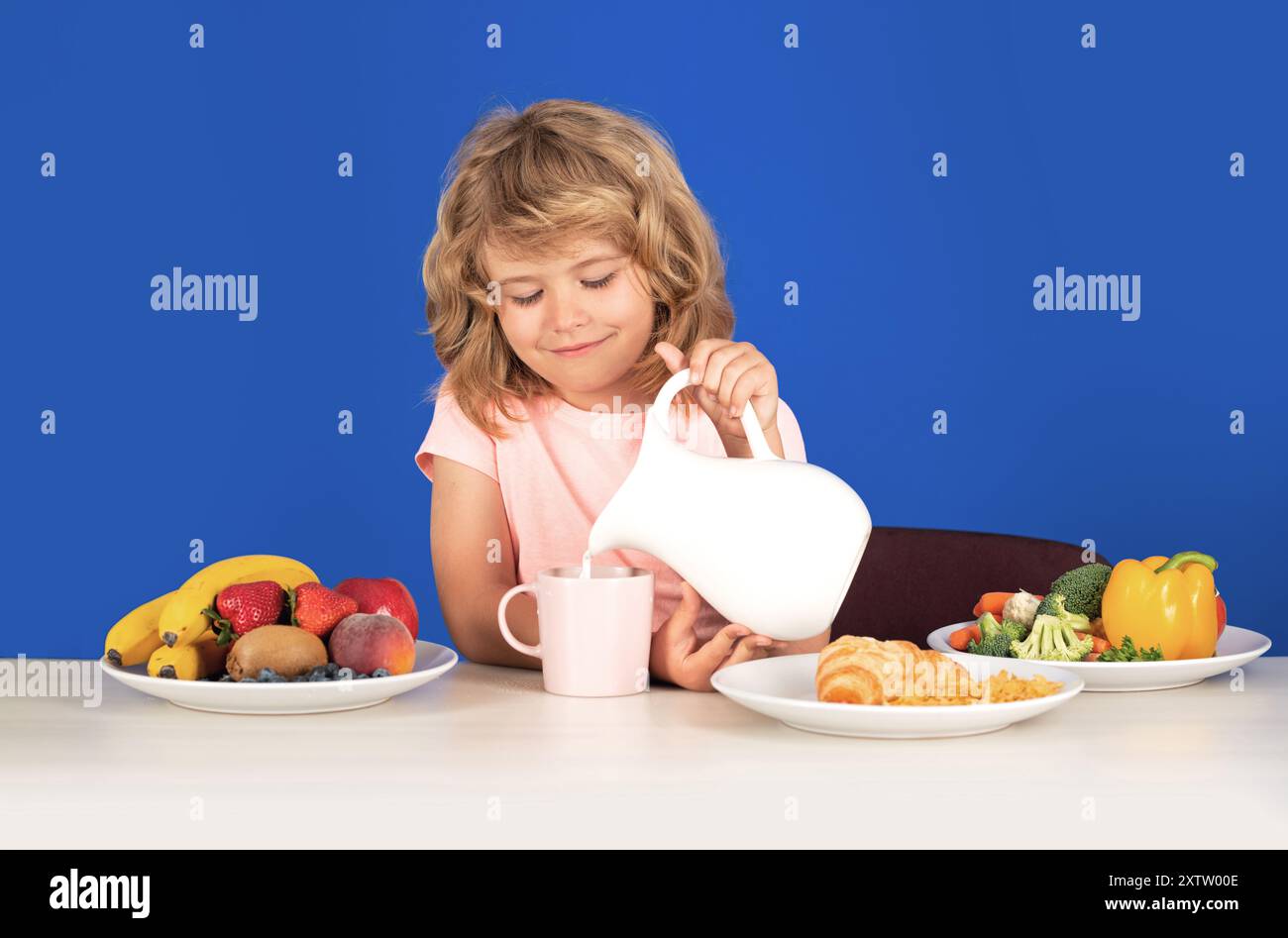 Kid boy pouring whole cows milk. Portrait of child eat fresh healthy ...