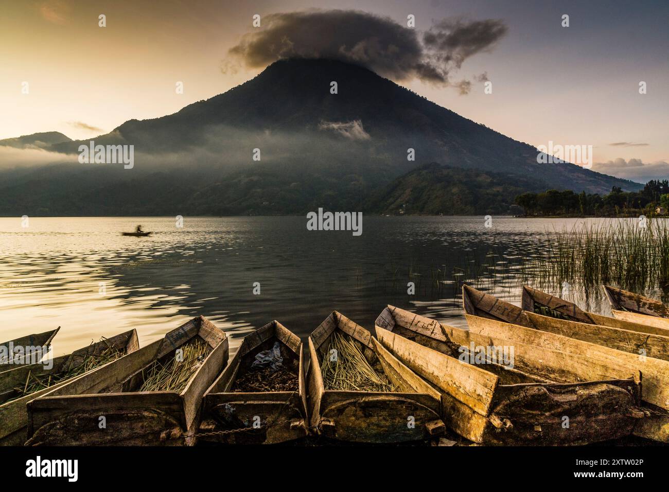 Canoes stranded on Lake Atitlan in front of the San Pedro volcano ...