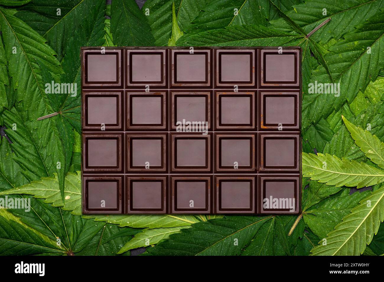 Chocolate bars on top of marijuana background top view Stock Photo - Alamy