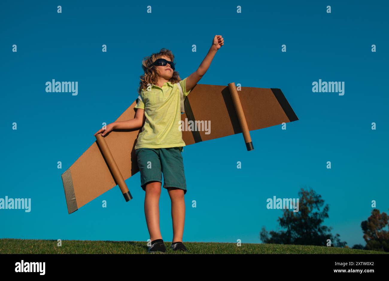Kid superhero with jetpack. Child pilot play on summer day. Success ...