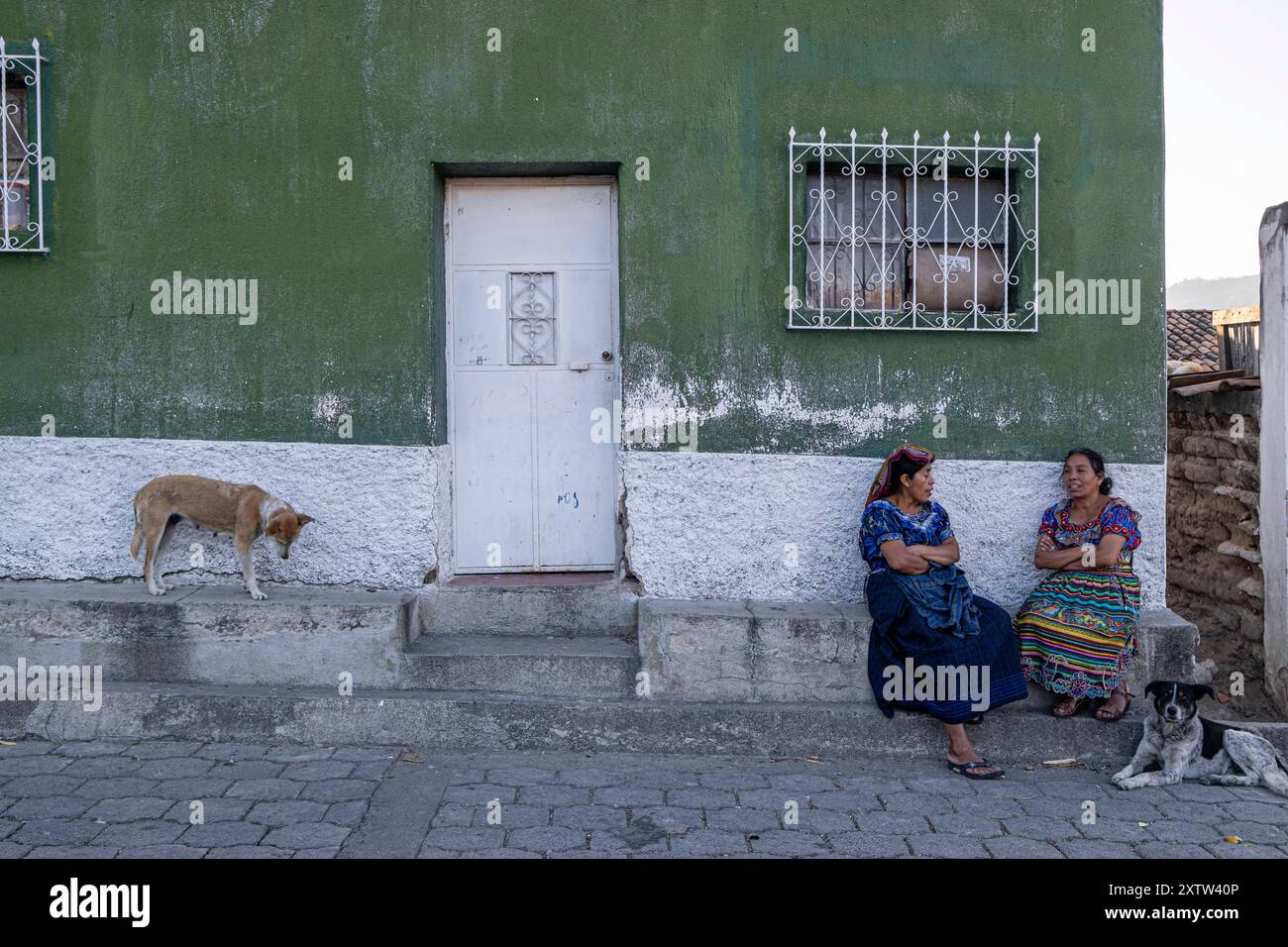 Women and dogs, San Bartolome Jocotenango, Guatemala, Central America ...