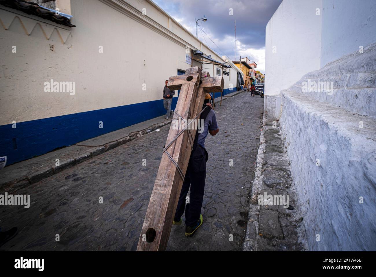 man carrying beams of a cross like a penitent, Chichicastenango, Quiche ...