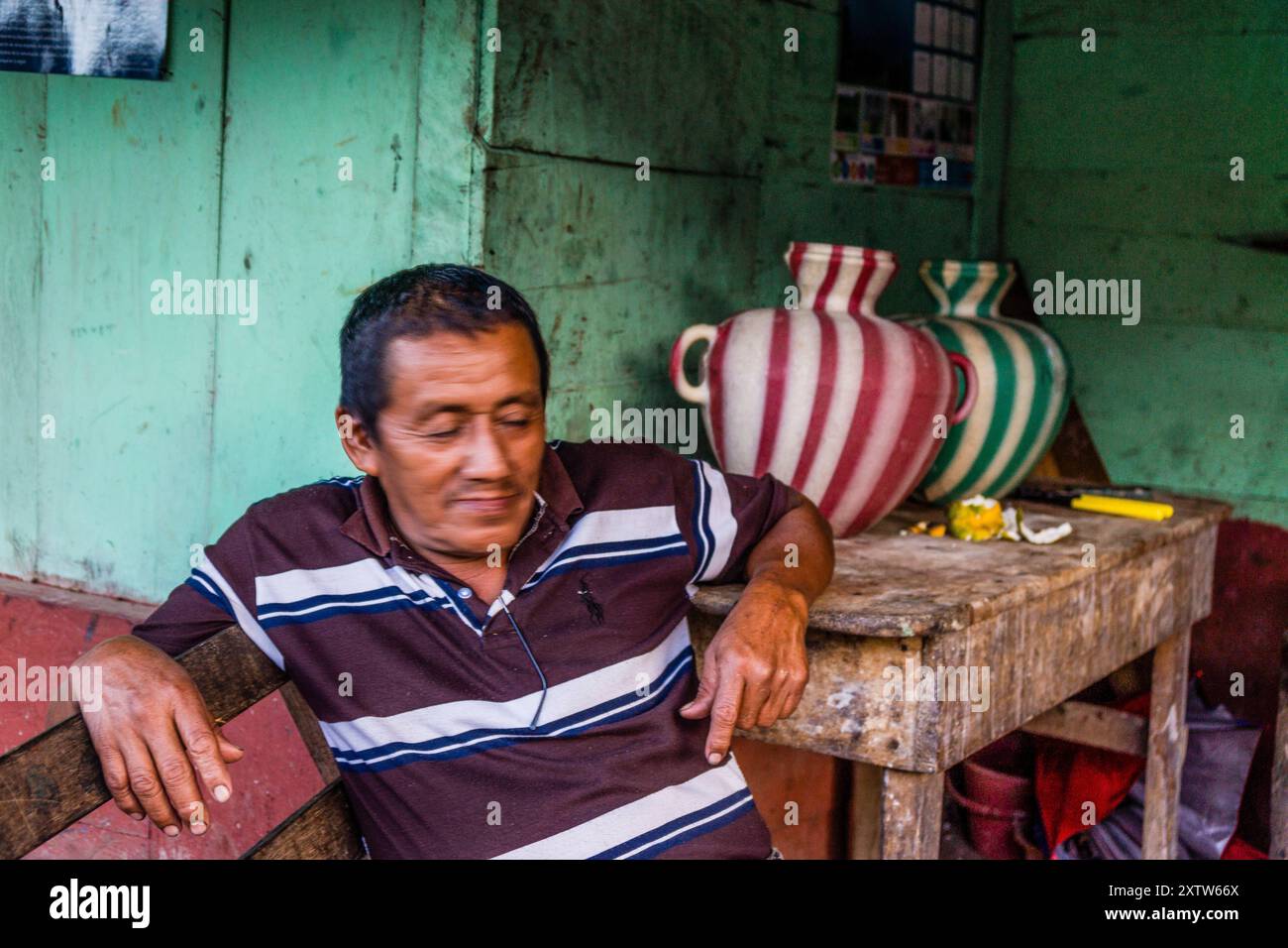 Man resting next to some pitchers, Lancetillo, La Parroquia, Reyna area ...
