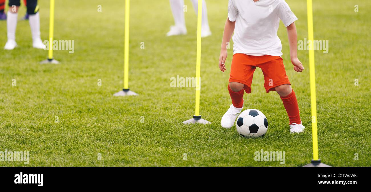 Child in Football Training. Player Kicking the Ball Between Training ...