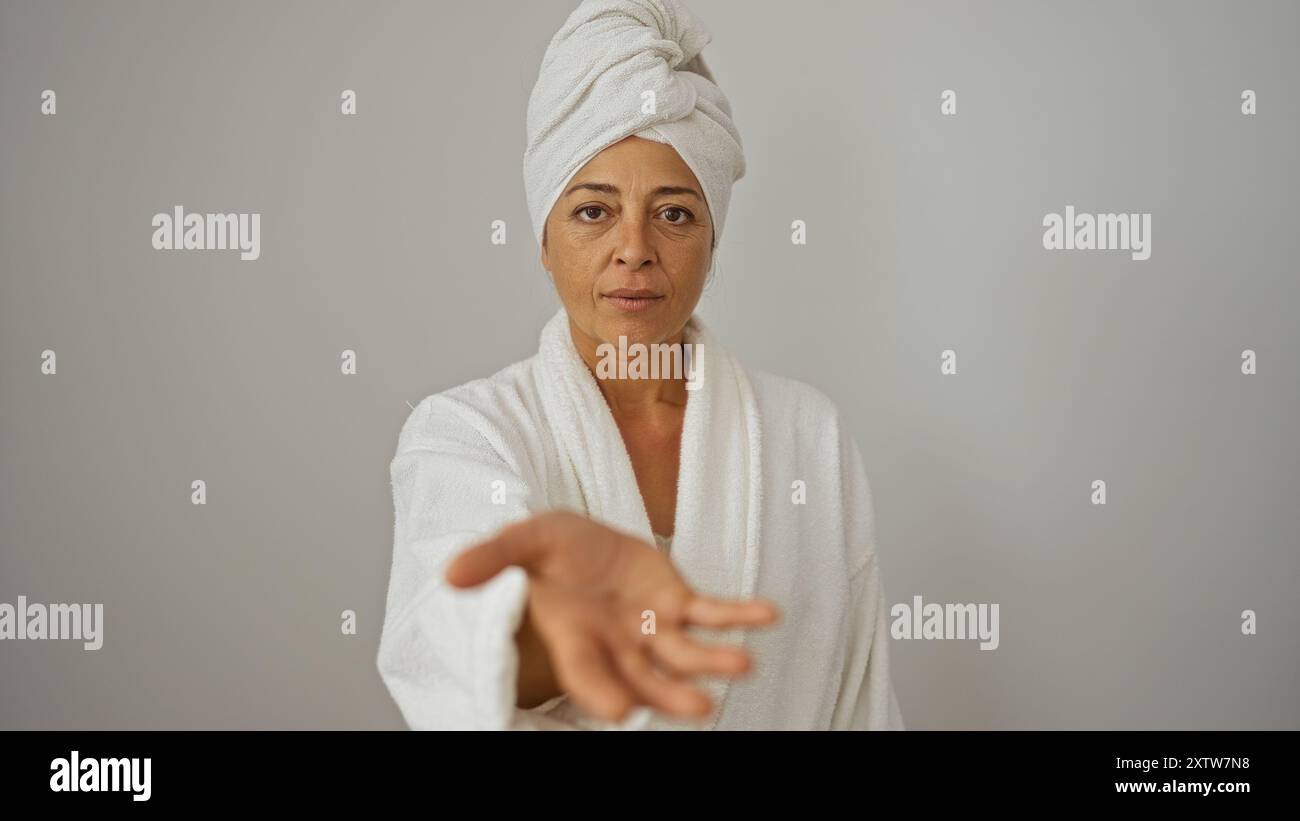 Beautiful mature hispanic woman standing over an isolated white ...