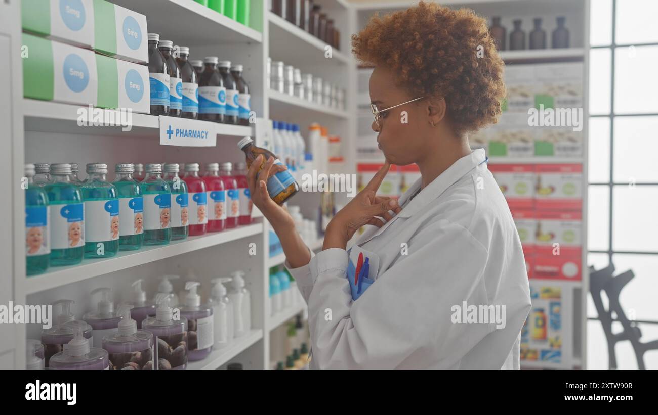 African american woman pharmacist examining medicine in a pharmacy ...