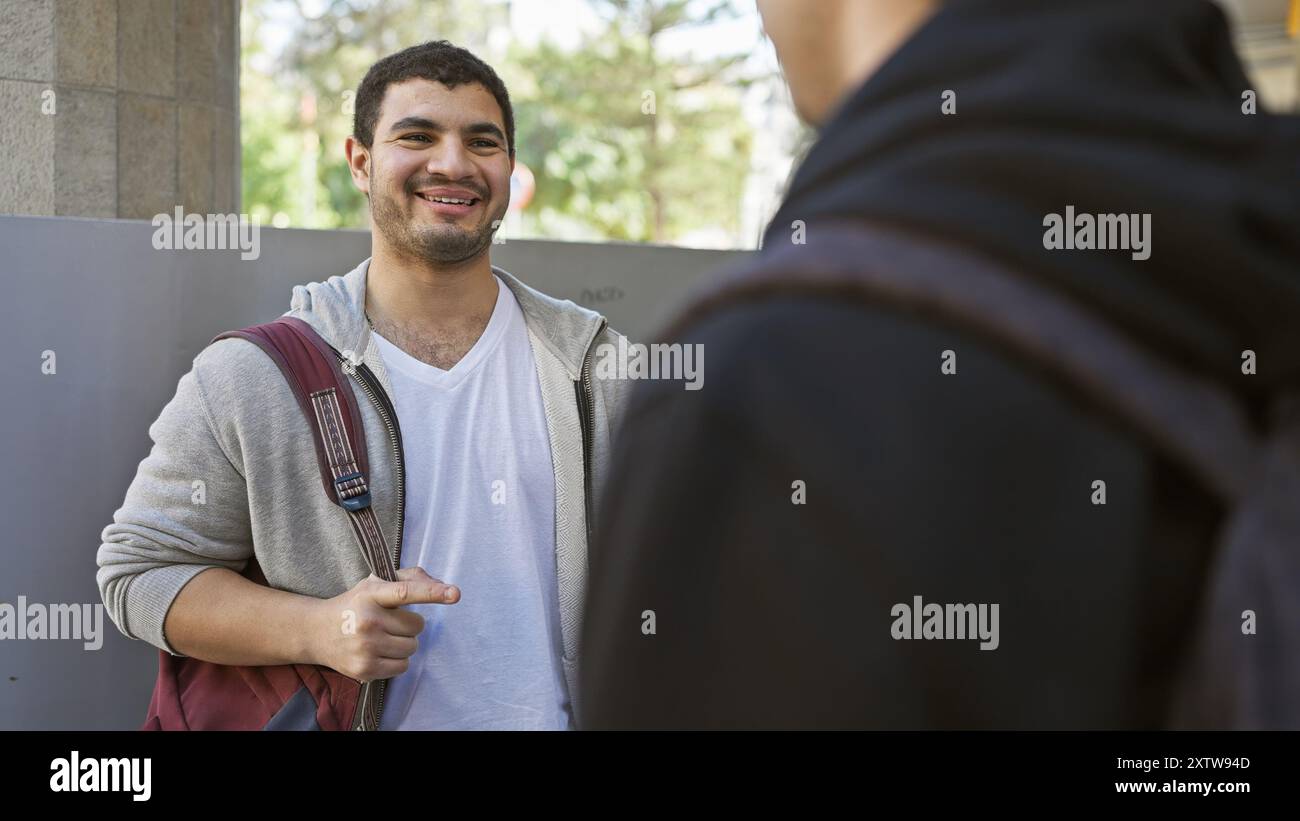 Two men talking outdoors in an urban environment, one smiling, creating ...
