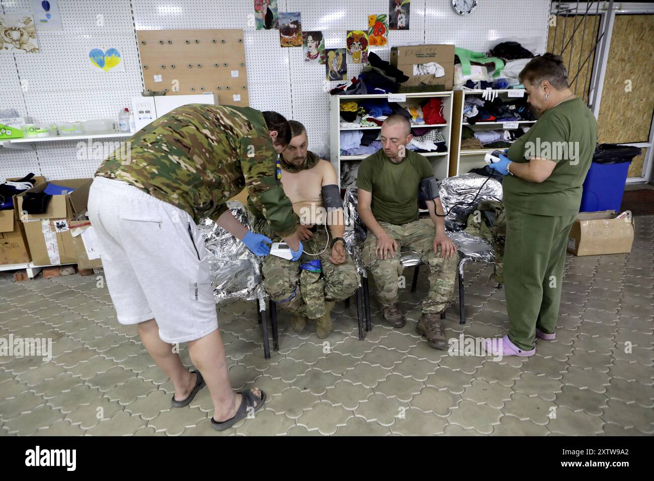 DONETSK REGION, UKRAINE - AUGUST 15, 2024 - Medics are treating ...