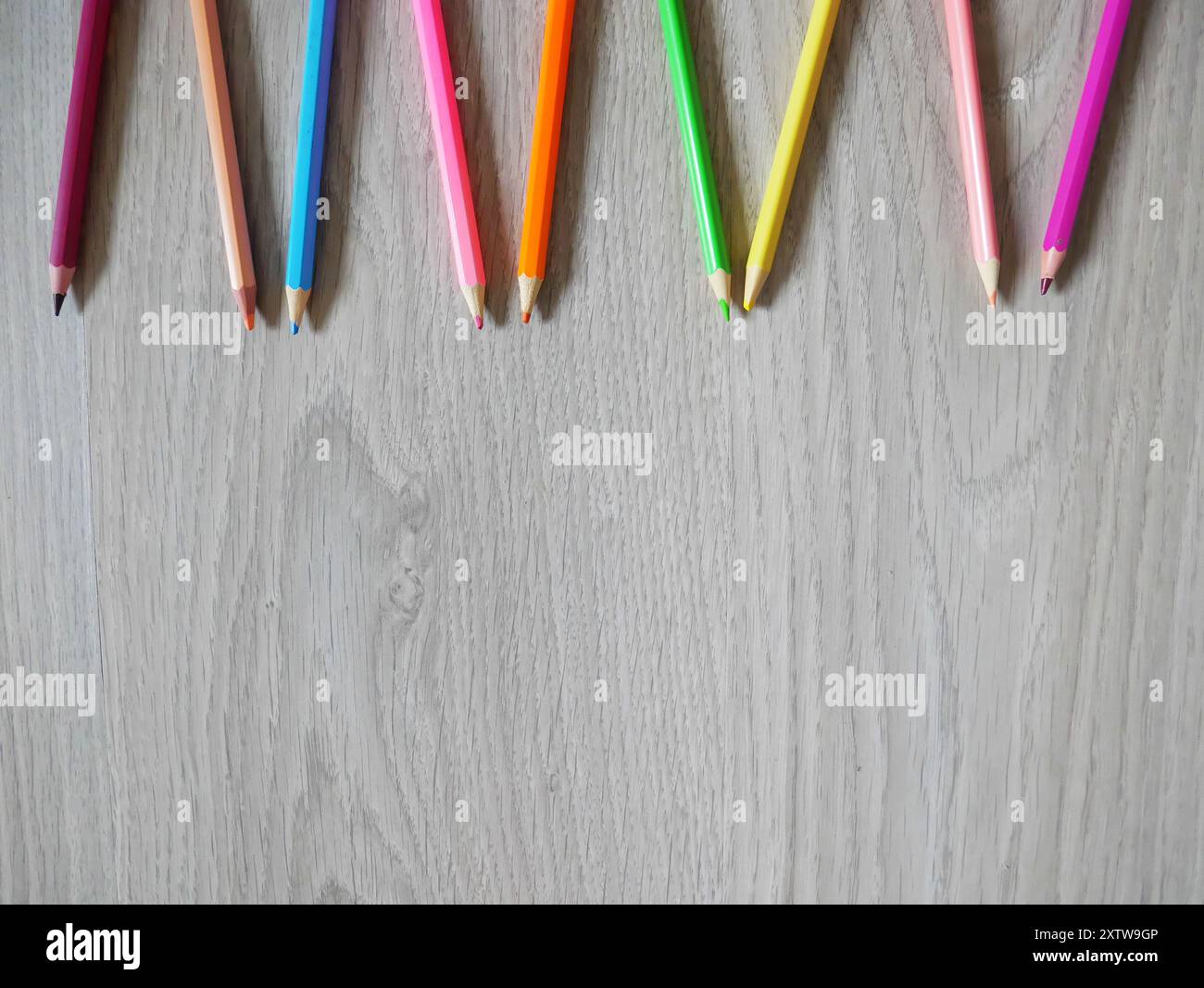 Photo of colored pencils on a wooden background for creative activities ...