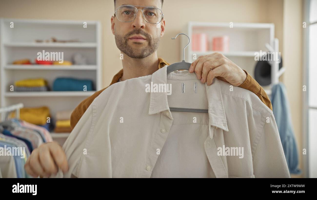 A stylish hispanic man choosing clothes in a well-organized wardrobe ...