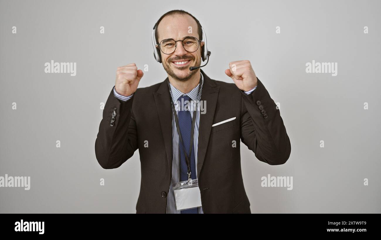 A cheerful bald hispanic man with a beard wearing a suit and a headset ...