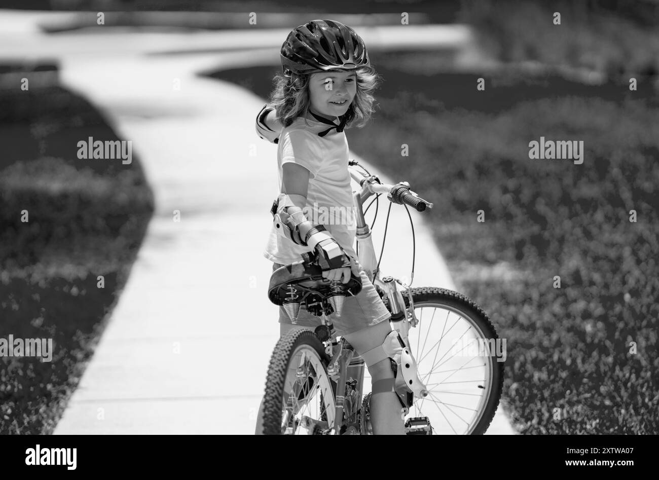 Child on bicycle outdoor. Boy in a helmet riding bike. Little cute ...
