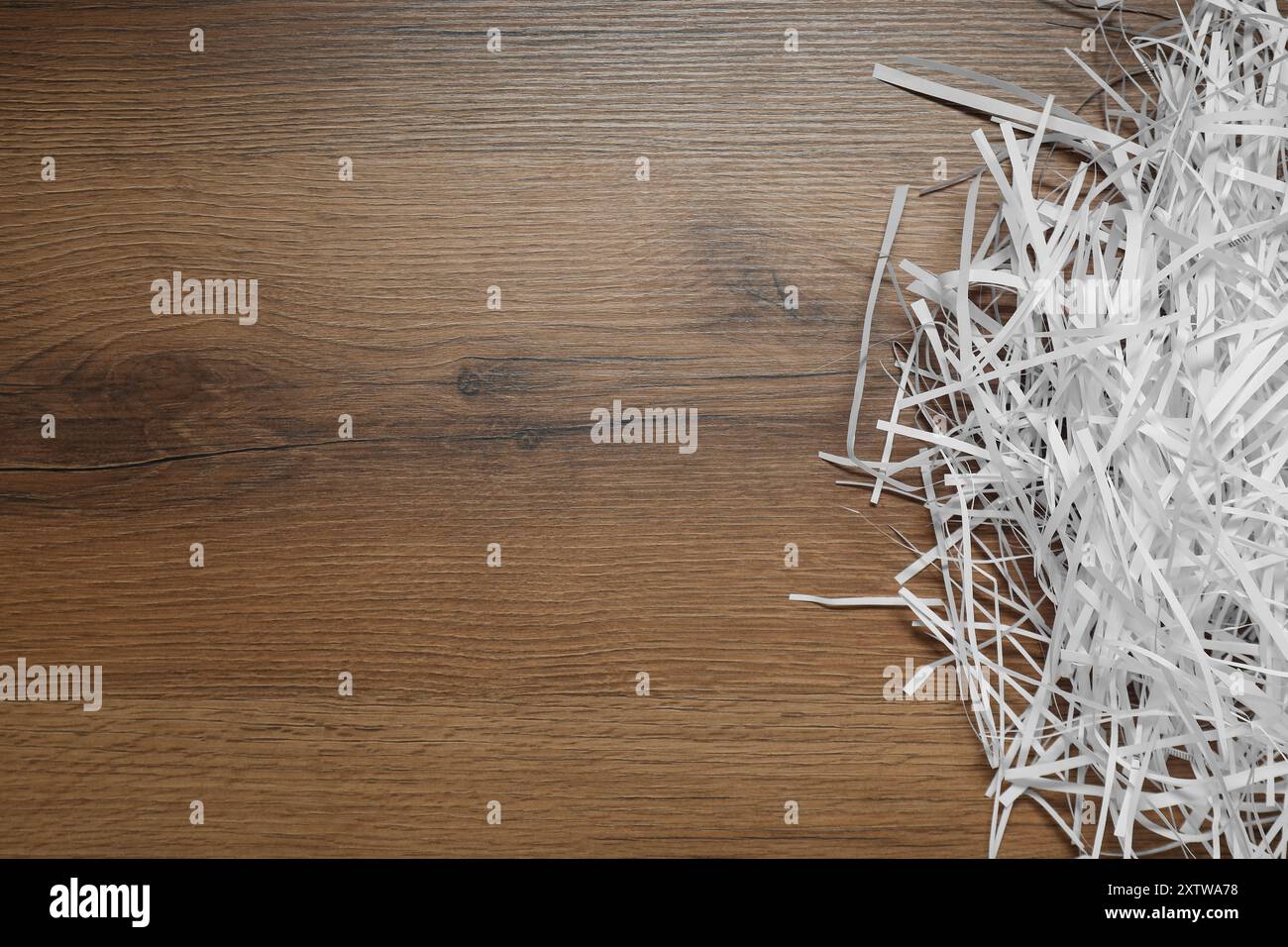 Shredded paper strips on wooden table, top view. Space for text Stock ...