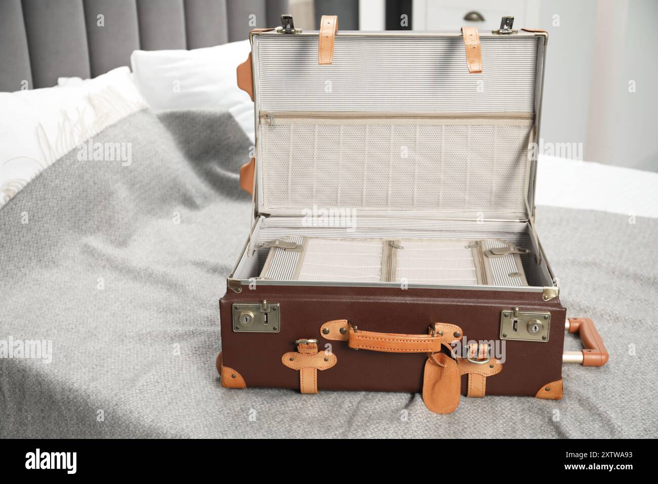 Open empty suitcase for travelling on bed indoors Stock Photo - Alamy