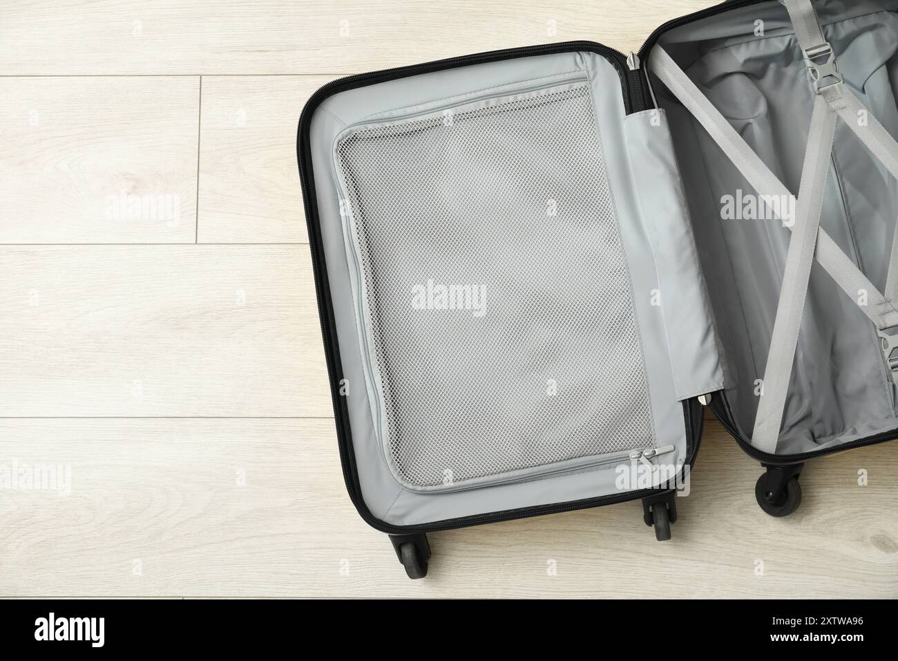 Open empty suitcase on floor indoors, top view. Space for text Stock ...