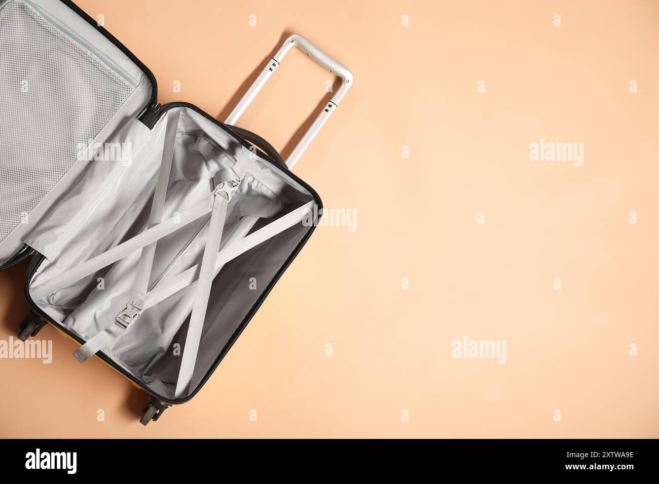 Open empty suitcase on beige background, top view. Space for text Stock ...